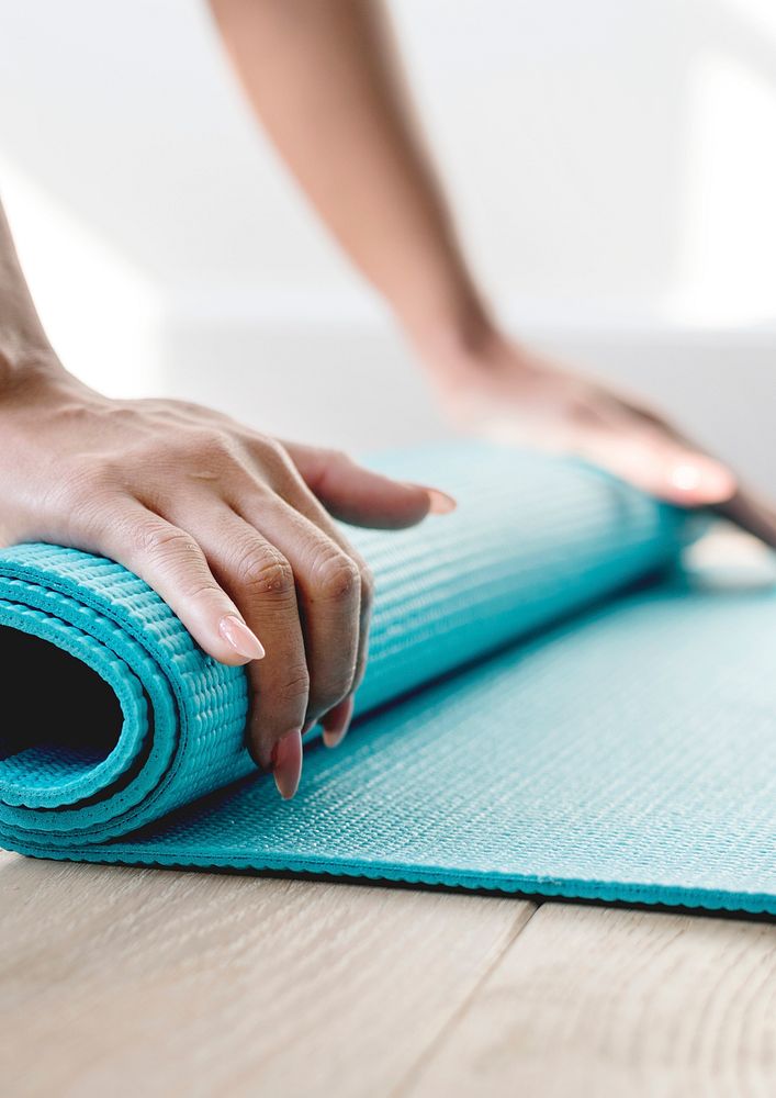 Woman rolling up a yoga | Free Photo - rawpixel