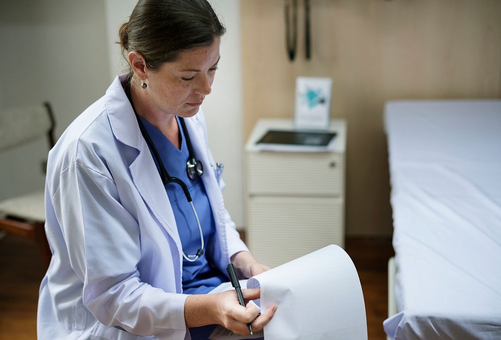 A Caucasian doctor working at a hospital | Photo - rawpixel
