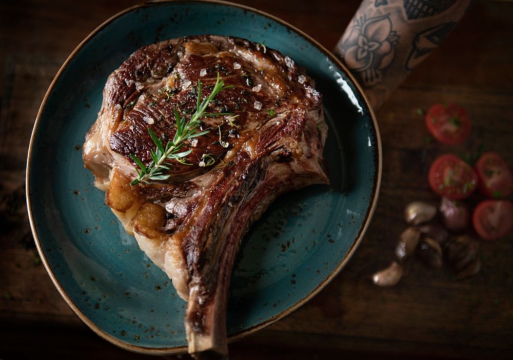 Tomahawk on a plate with garnish | Premium Photo - rawpixel