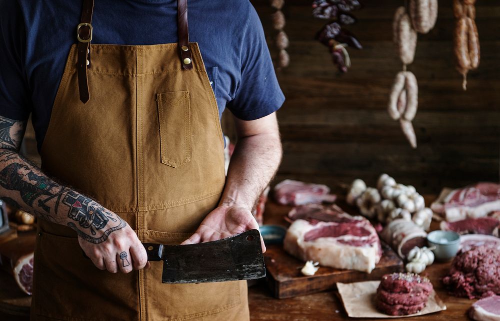 Butcher selling meat in a butcher | Premium Photo - rawpixel