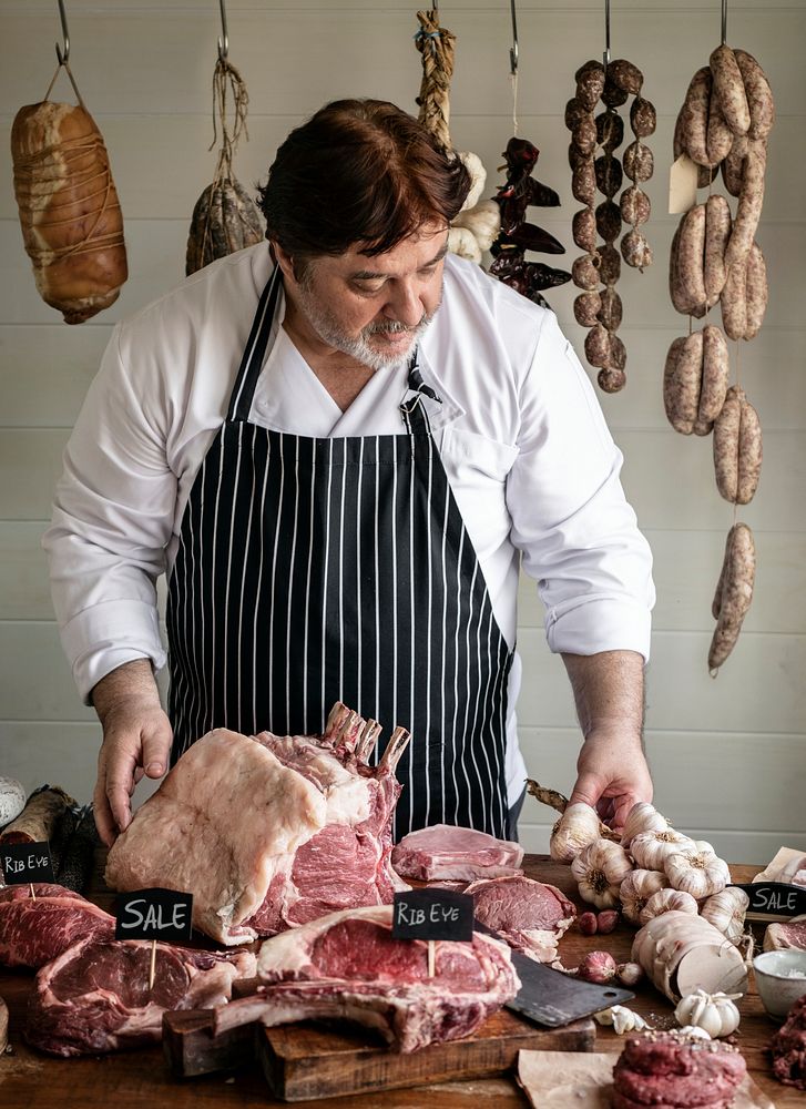 Butcher selling meat in a butcher | Premium Photo - rawpixel