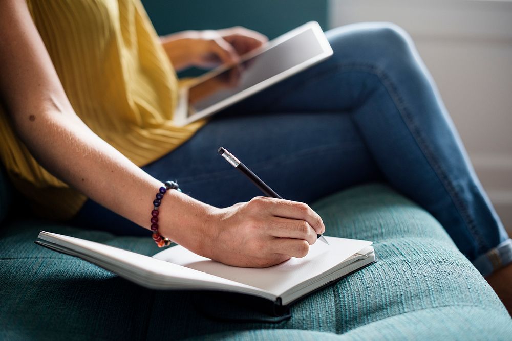 Woman taking notes as she | Premium Photo - rawpixel
