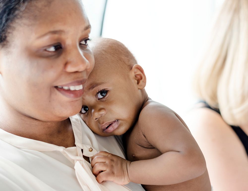 Mother carrying her cute baby | Premium Photo - rawpixel