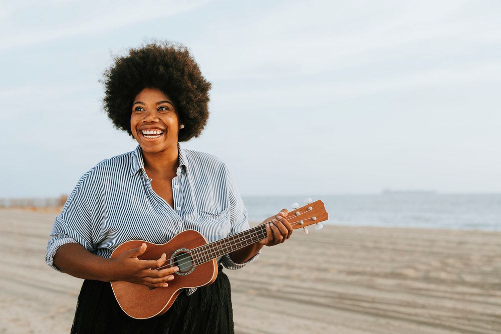 African American musician playing ukulele | Photo - rawpixel
