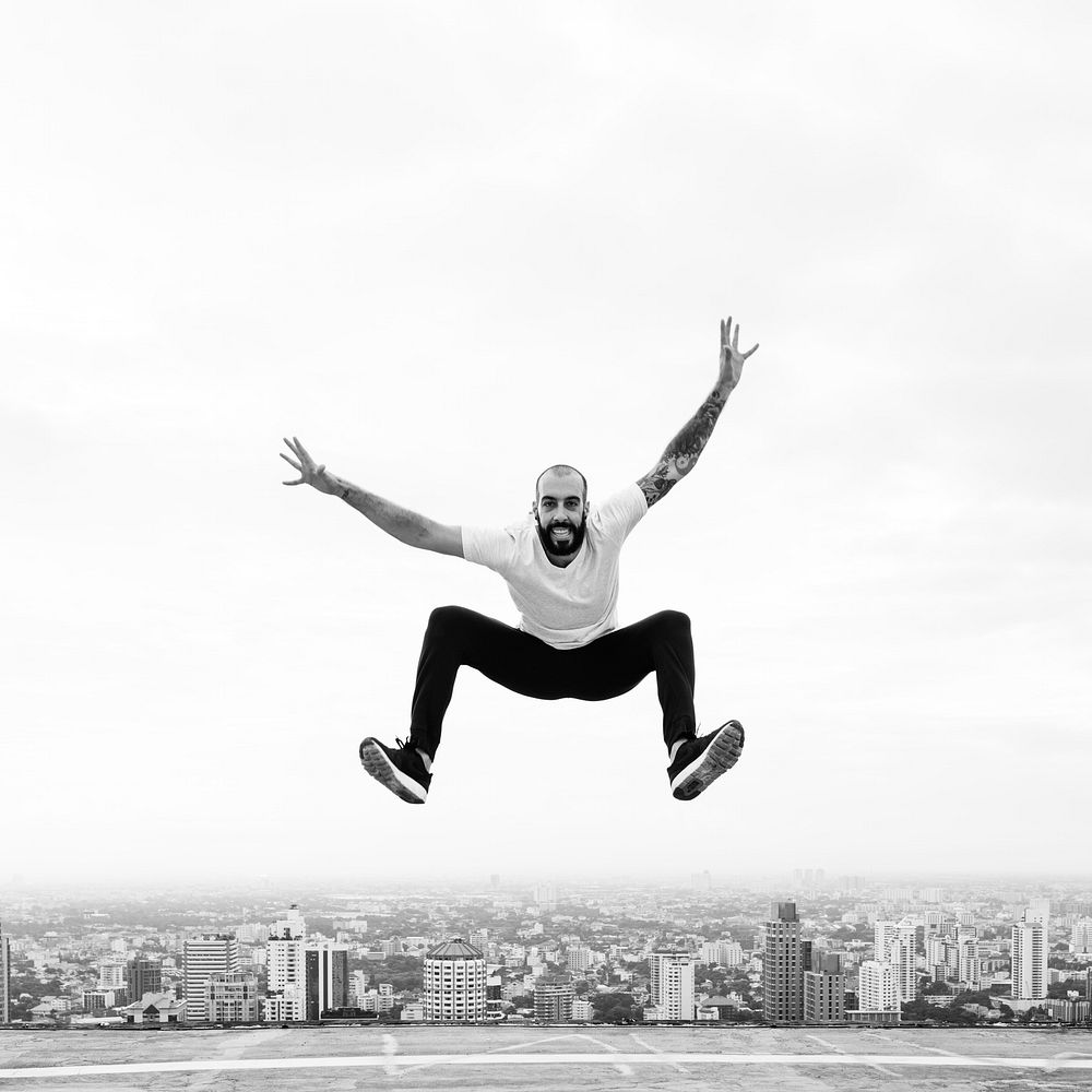 Man jumping on a rooftop | Photo - rawpixel