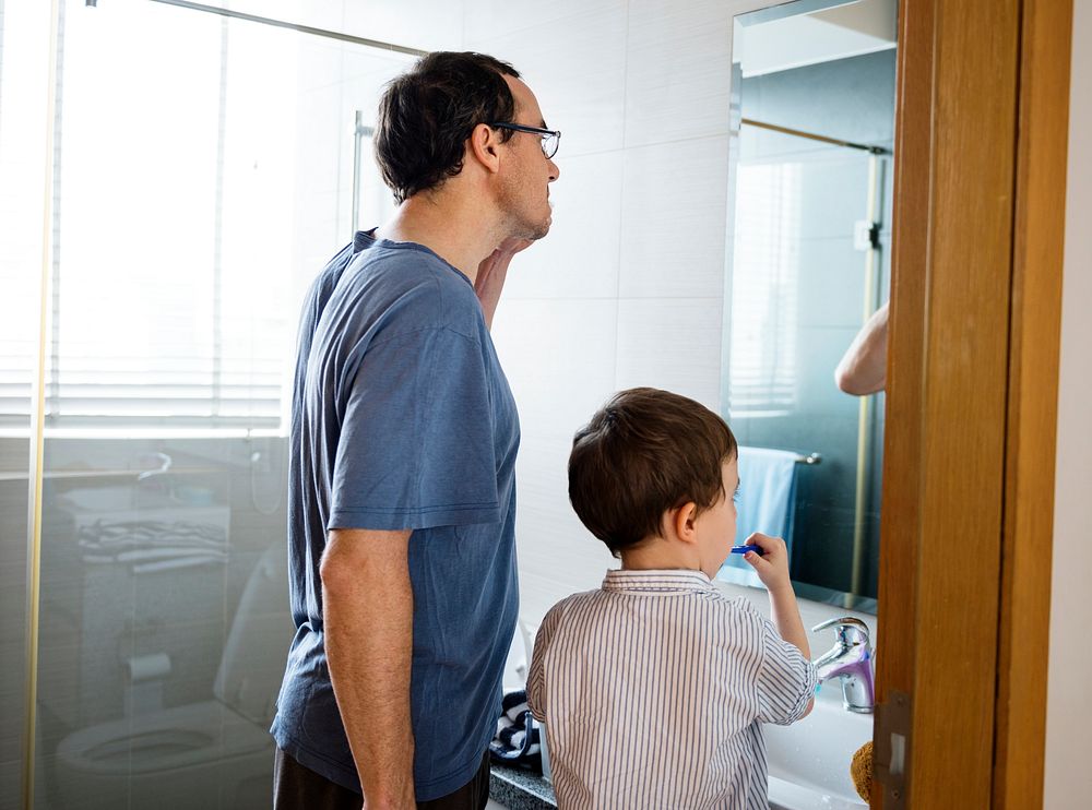 Father teaching son how to brush | Photo - rawpixel