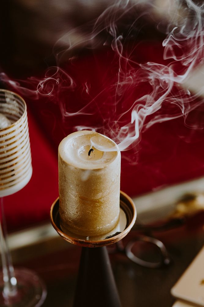 Blown out bronze candle on a candlestick | Premium Photo - rawpixel
