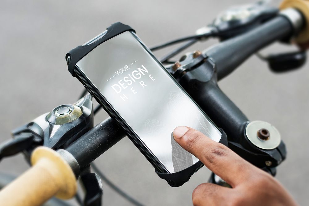 Cyclist using a phone on a bike | Premium PSD Mockup - rawpixel