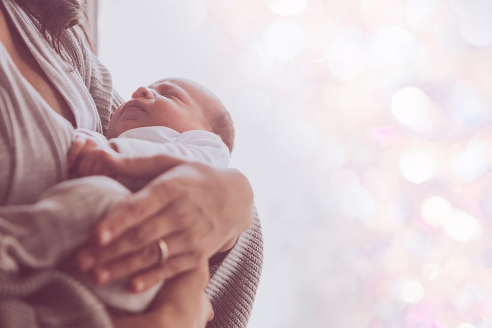 Loving mother cradle holding a newborn | Free Photo - rawpixel