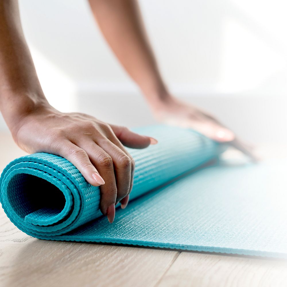 Woman rolling up a yoga | Free Photo - rawpixel