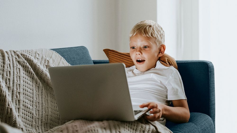 Young boy watching videos on his | Free Photo - rawpixel