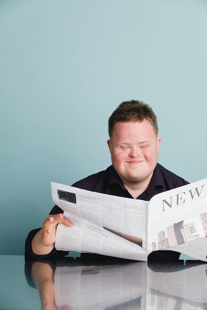 Boy with down syndrome reading | Free Photo - rawpixel