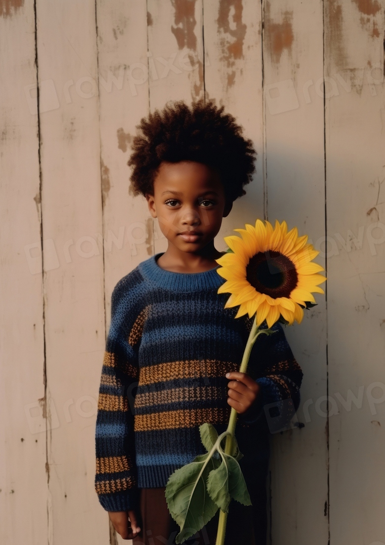 black boy carry big sunflower | Free Photo - rawpixel