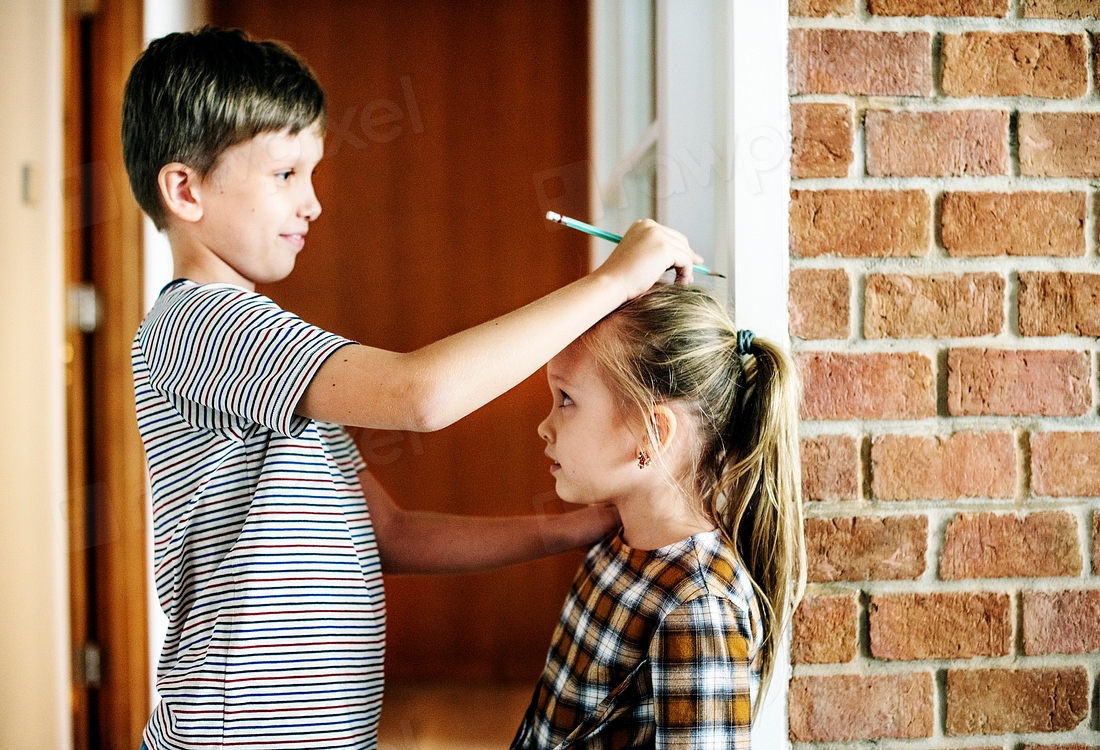 Siblings checking height | Free Photo - rawpixel