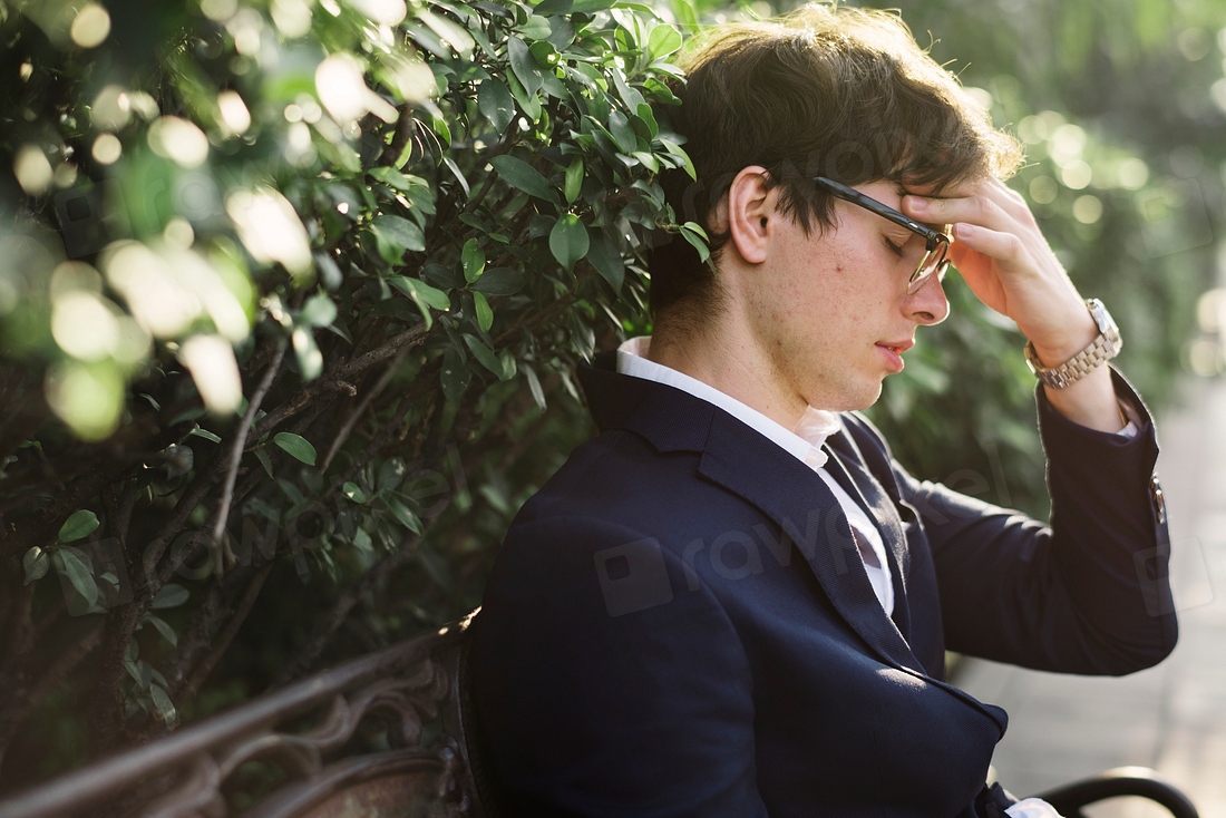 Man sitting down and holding | Premium Photo - rawpixel