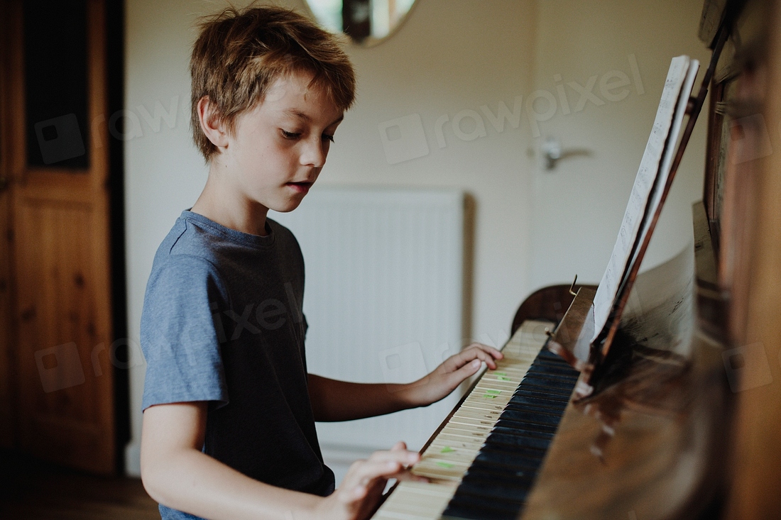 Young boy playing the piano | Free Photo - rawpixel