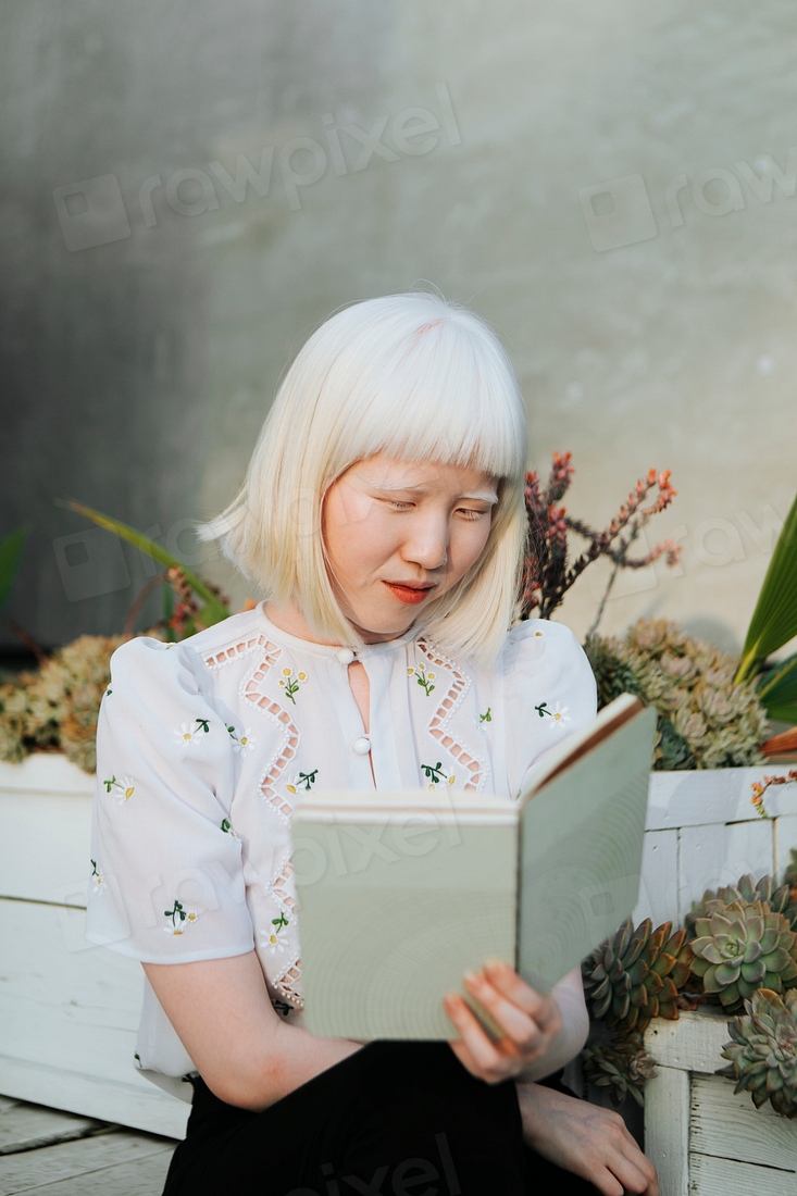 Cute albino girl reading book | Premium Photo - rawpixel