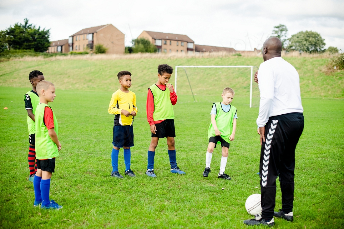 Football coach training his junior | Premium Photo - rawpixel
