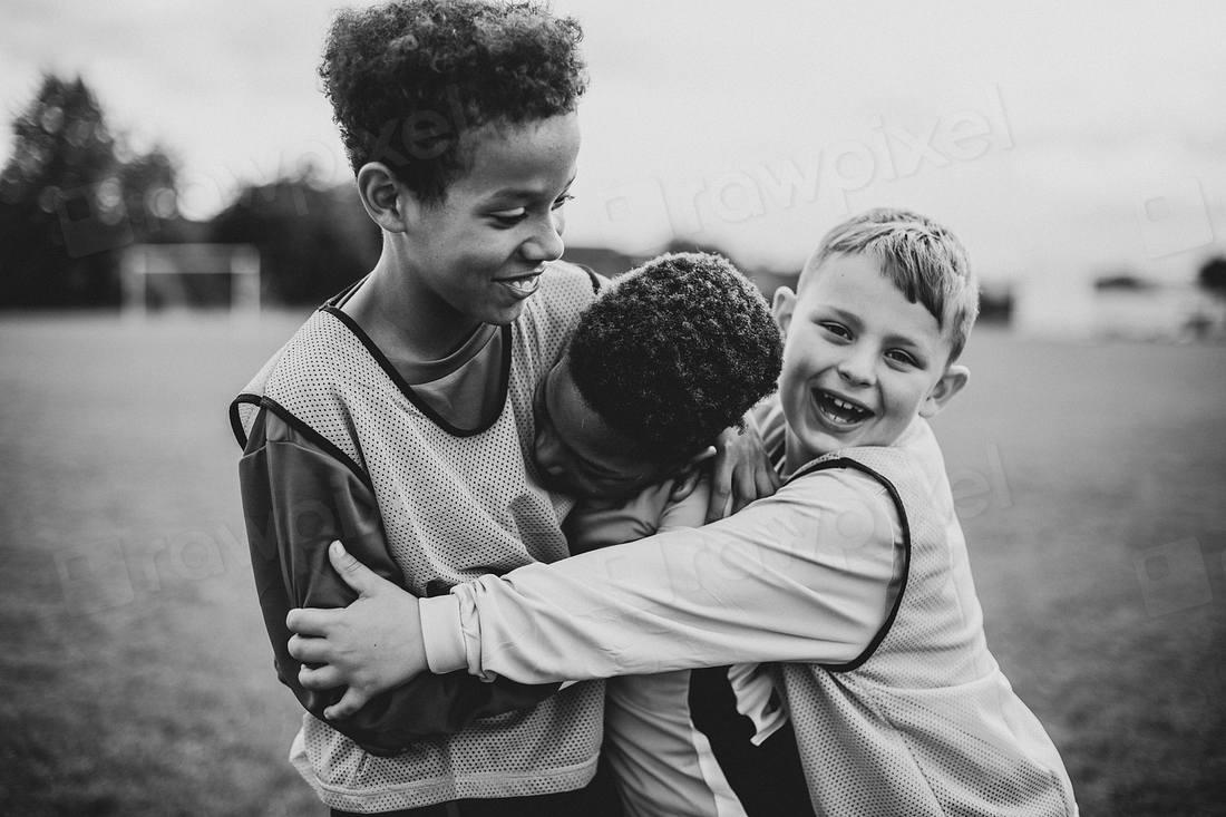 Junior football team hugging each | Free Photo - rawpixel
