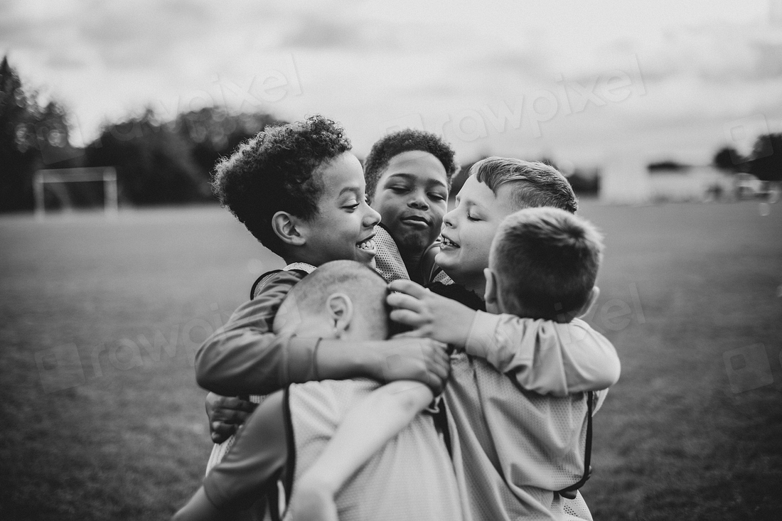 Junior football team hugging each | Free Photo - rawpixel