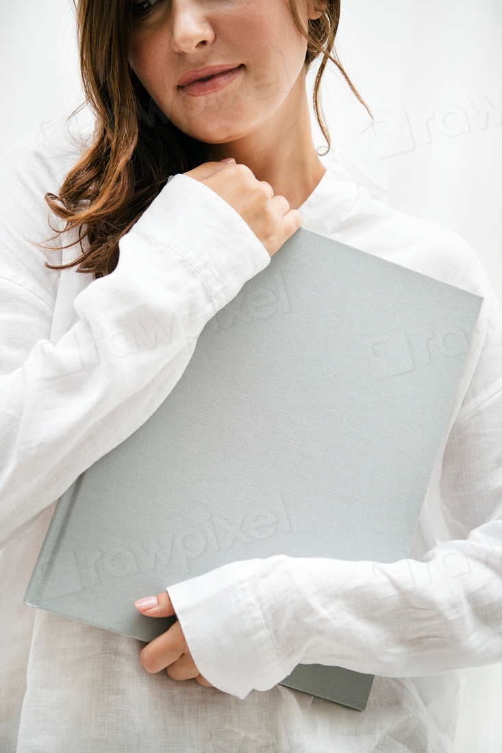Cheerful woman holding gray book | Premium Photo - rawpixel