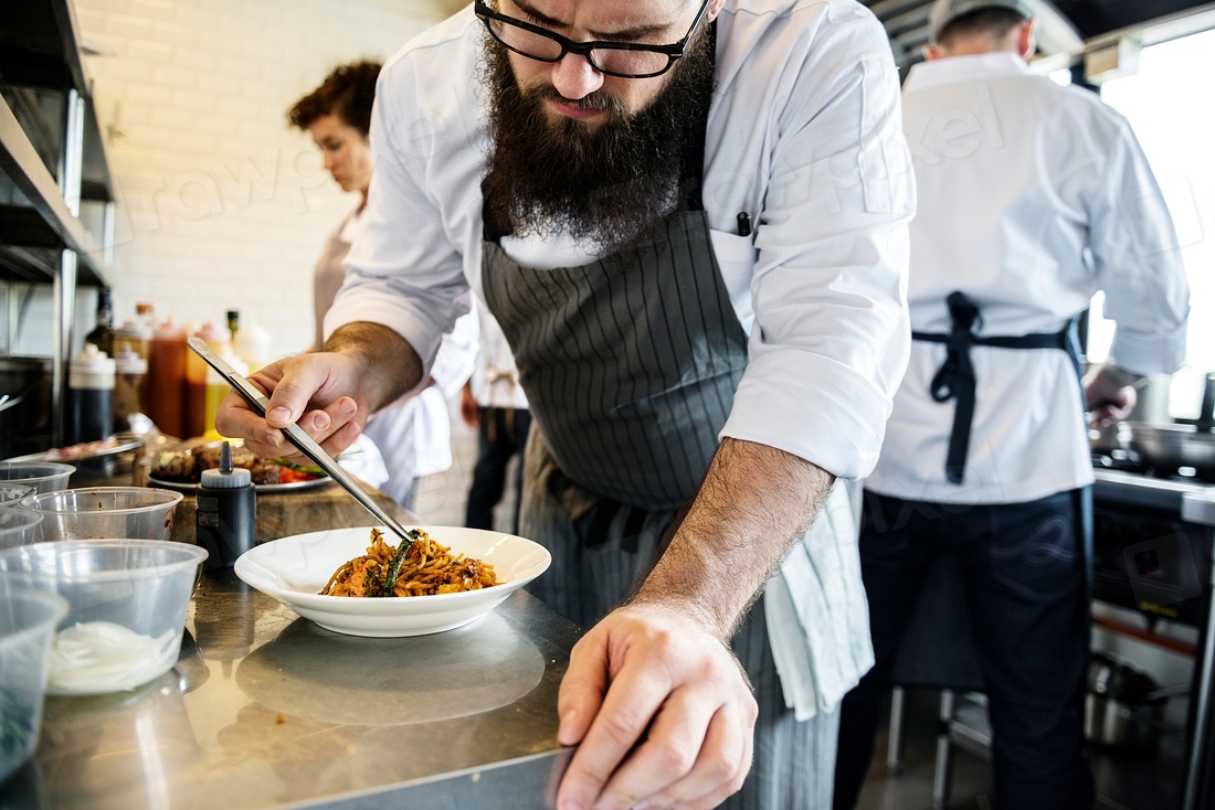 Kitchen staff decorating cooked dish | Premium Photo - rawpixel