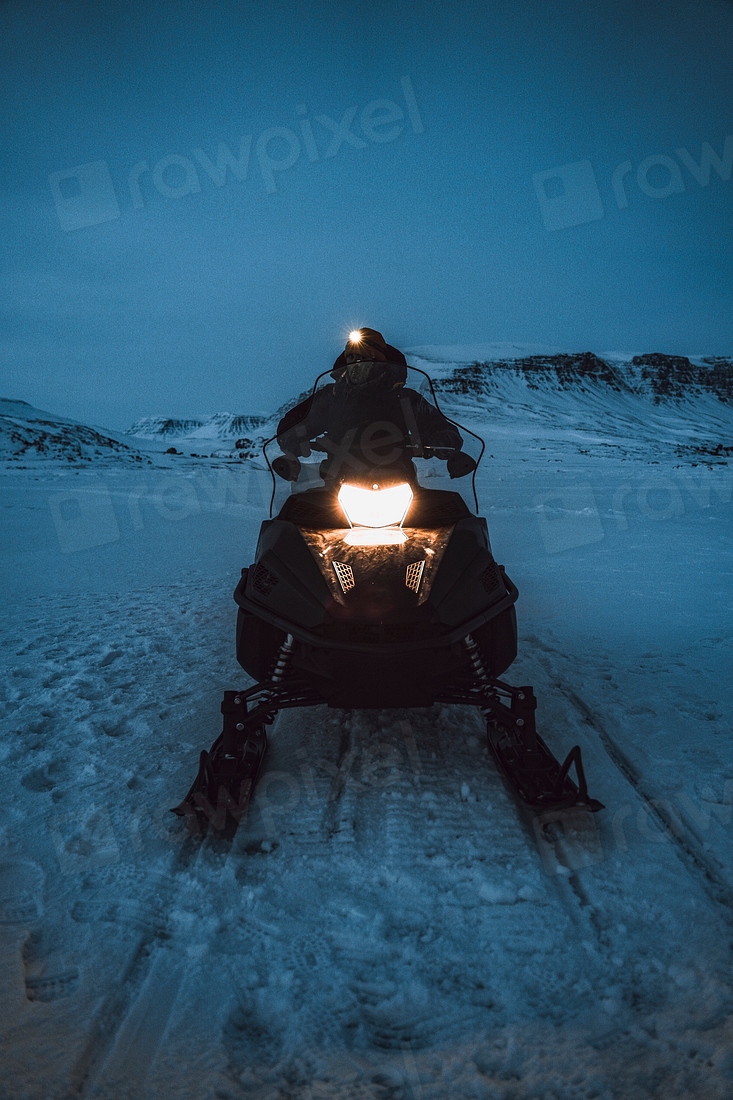 Man riding snowmobile evening | Premium Photo - rawpixel
