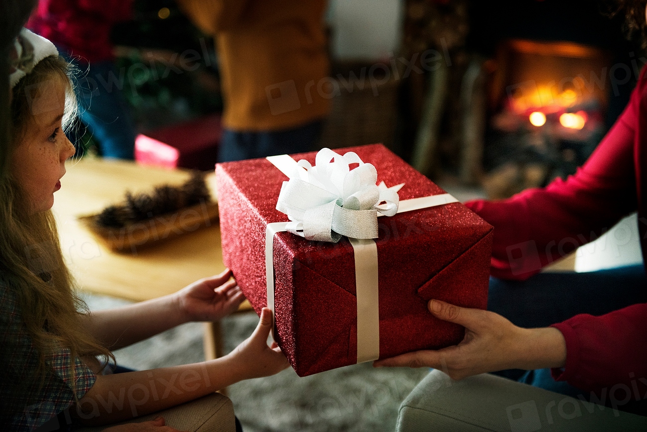 Little girl receiving Christmas present | Free Photo - rawpixel