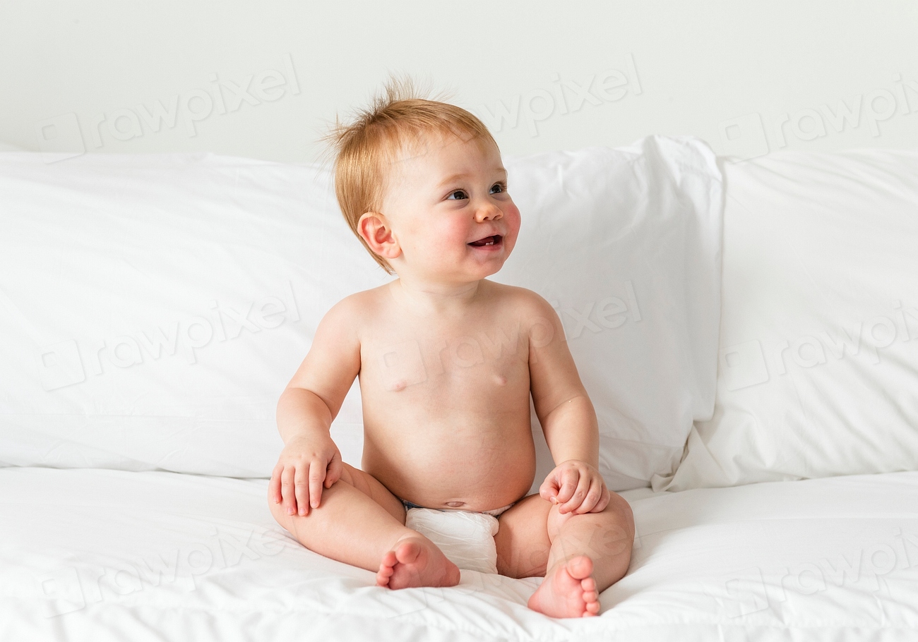 Smiling baby sitting bed | Free Photo - rawpixel