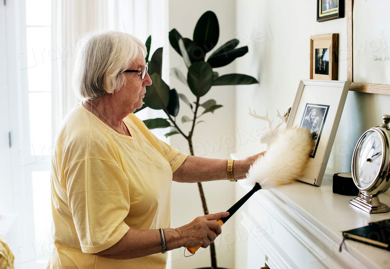 Senior woman dusting family photo | Premium Photo - rawpixel