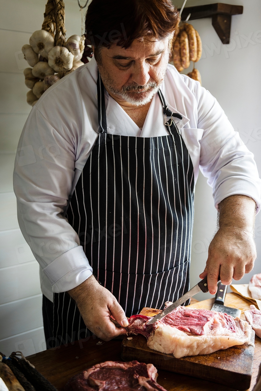 Butcher cutting rib eye steak | Photo - rawpixel