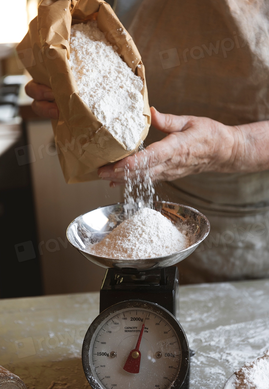 Baker weighing flour on a scale | Photo - rawpixel