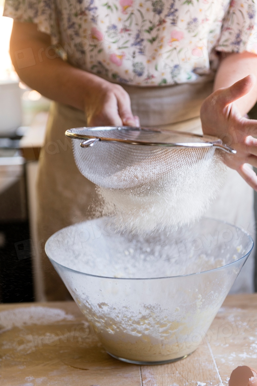Woman sieving flour into a bowl | Premium Photo - rawpixel