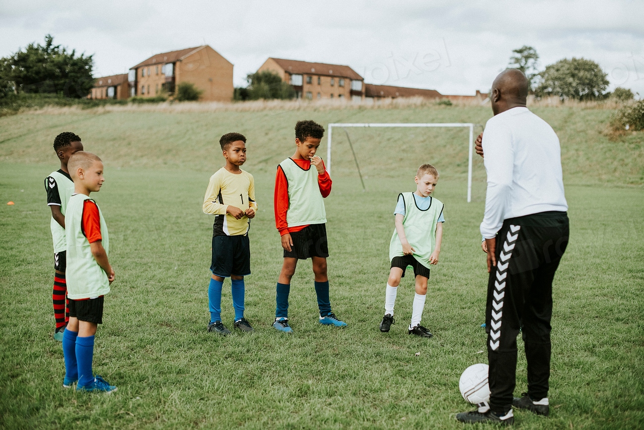 Football coach training his junior | Free Photo - rawpixel