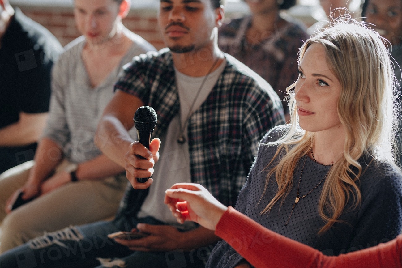 Man handing a microphone to a woman | Premium Photo - rawpixel