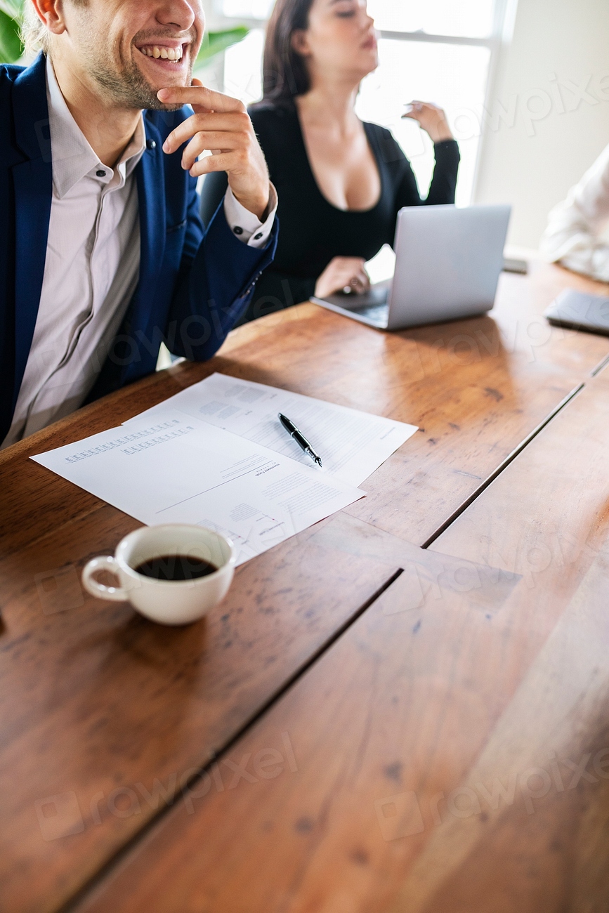Smiling businessman in a meeting | Photo - rawpixel
