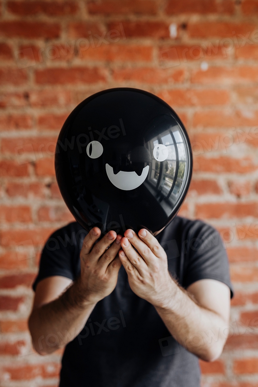 Man holding cute black Halloween | Premium Photo - rawpixel