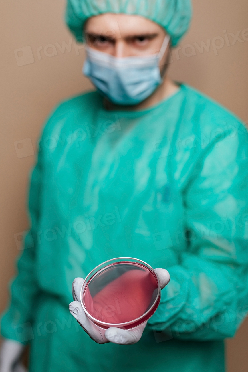 Microbiologist green gown holding an | Free Photo - rawpixel