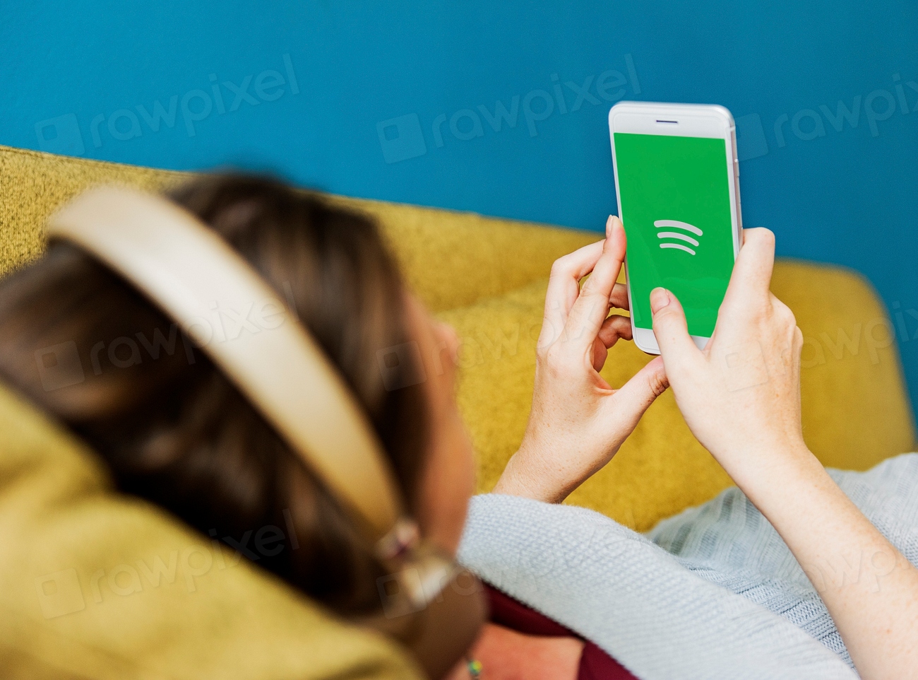 Woman using Spotify application phone. | Free Photo - rawpixel