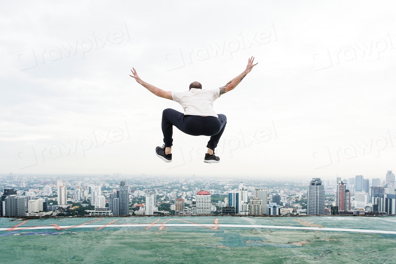 Man jumping on the rooftop | Free Photo - rawpixel