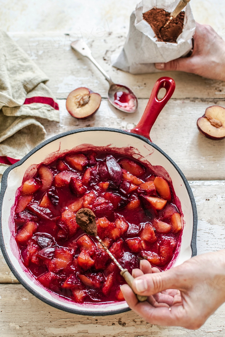 Woman adding cocoa powder plums | Premium Photo - rawpixel