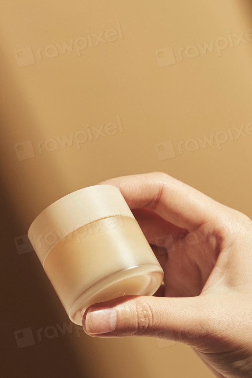 Hand holding beige cream pot | Premium Photo - rawpixel