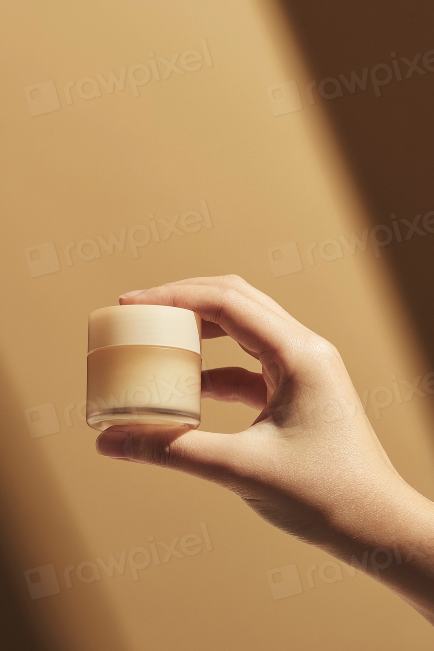 Hand holding beige cream pot | Premium Photo - rawpixel