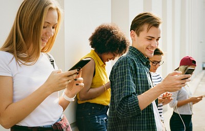 Friends using smartphones outdoors together | Premium Photo - rawpixel