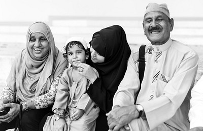 Muslim family sitting together outdoors | Free Photo - rawpixel