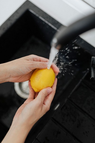 Woman rinsing yellow lemon sink | Premium Photo - rawpixel