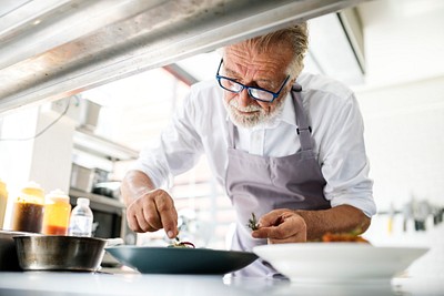 Kitchen staff decorating cooked dish | Premium Photo - rawpixel