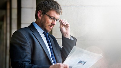 Businessman reading a marketing newspaper | Premium Photo - rawpixel