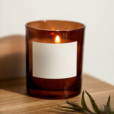 Lit scented candle, blank label, | Free Photo - rawpixel