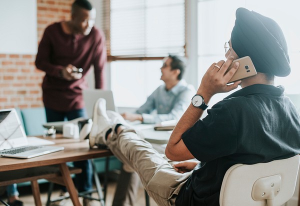Male entrepreneur taking call an | Premium Photo - rawpixel